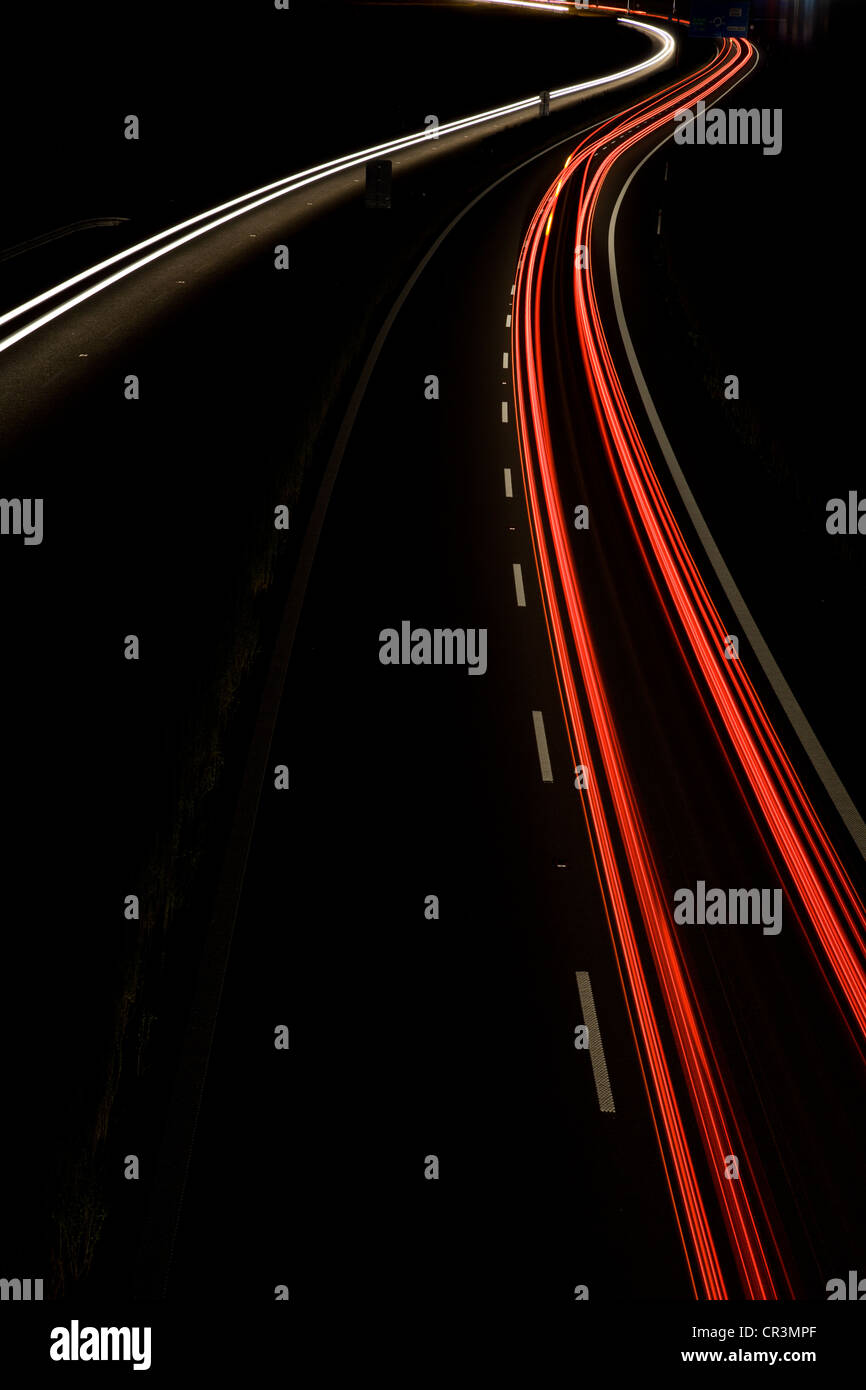 Cars moving fast on a night highway (motion blurred image Stock Photo ...