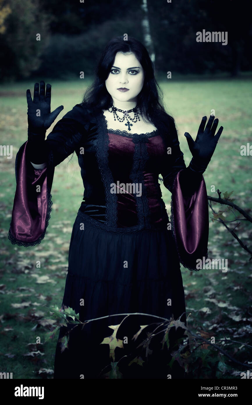 Woman, Gothic, standing, serious, raised hands Stock Photo - Alamy