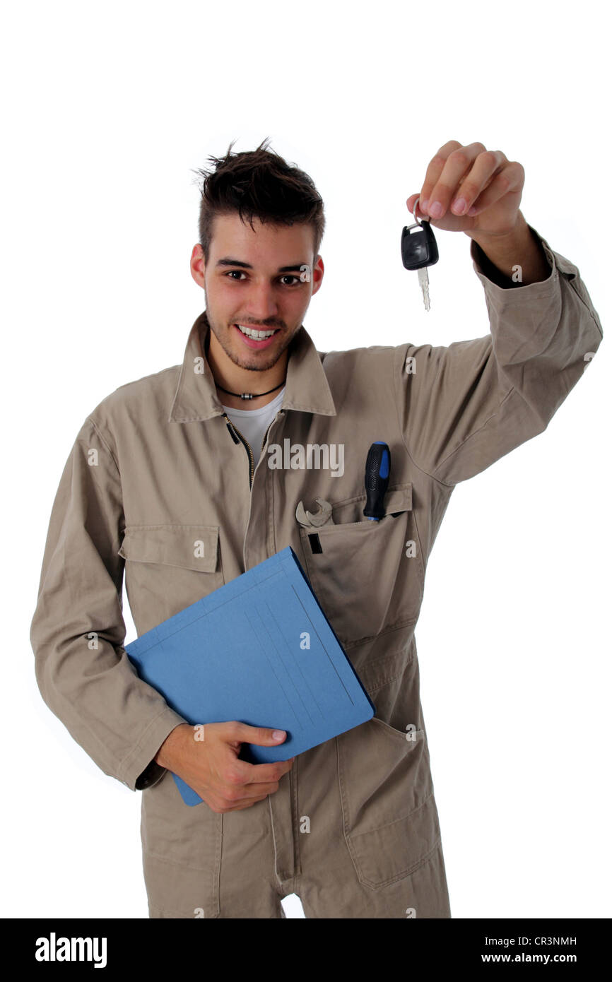 Friendly mechanic clutching the job card and holding up car keys to ...