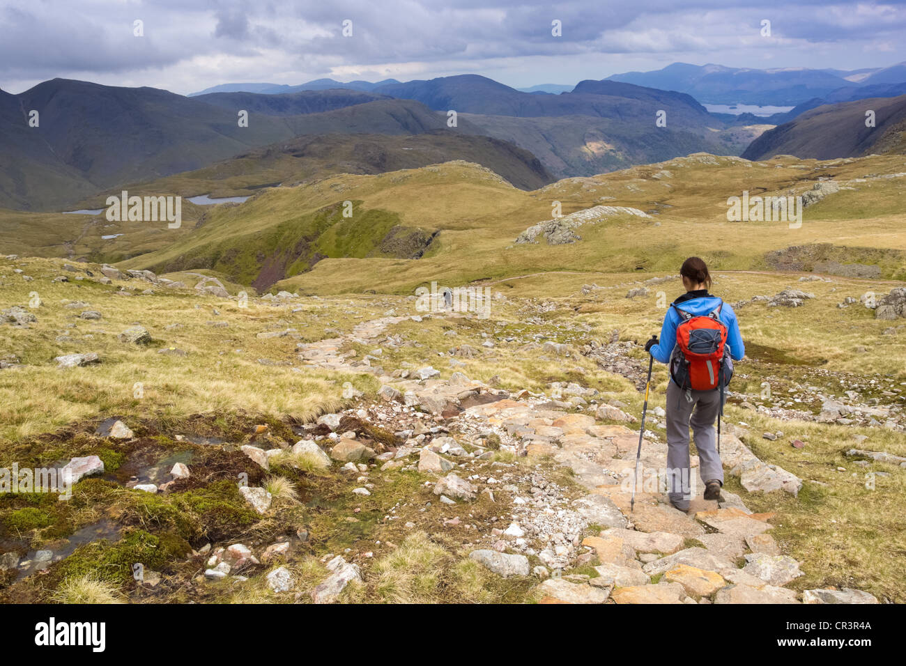 Walking down from Scafell in the Lake District, a Hiker passes Esk ...