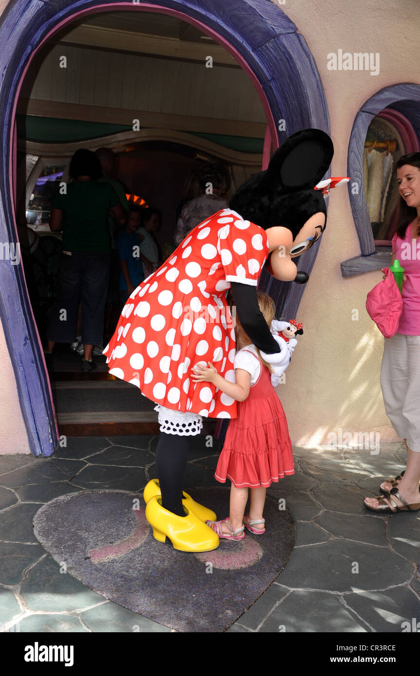 A little girl receives a hug from Minnie Mouse at Disneyland in sunny ...