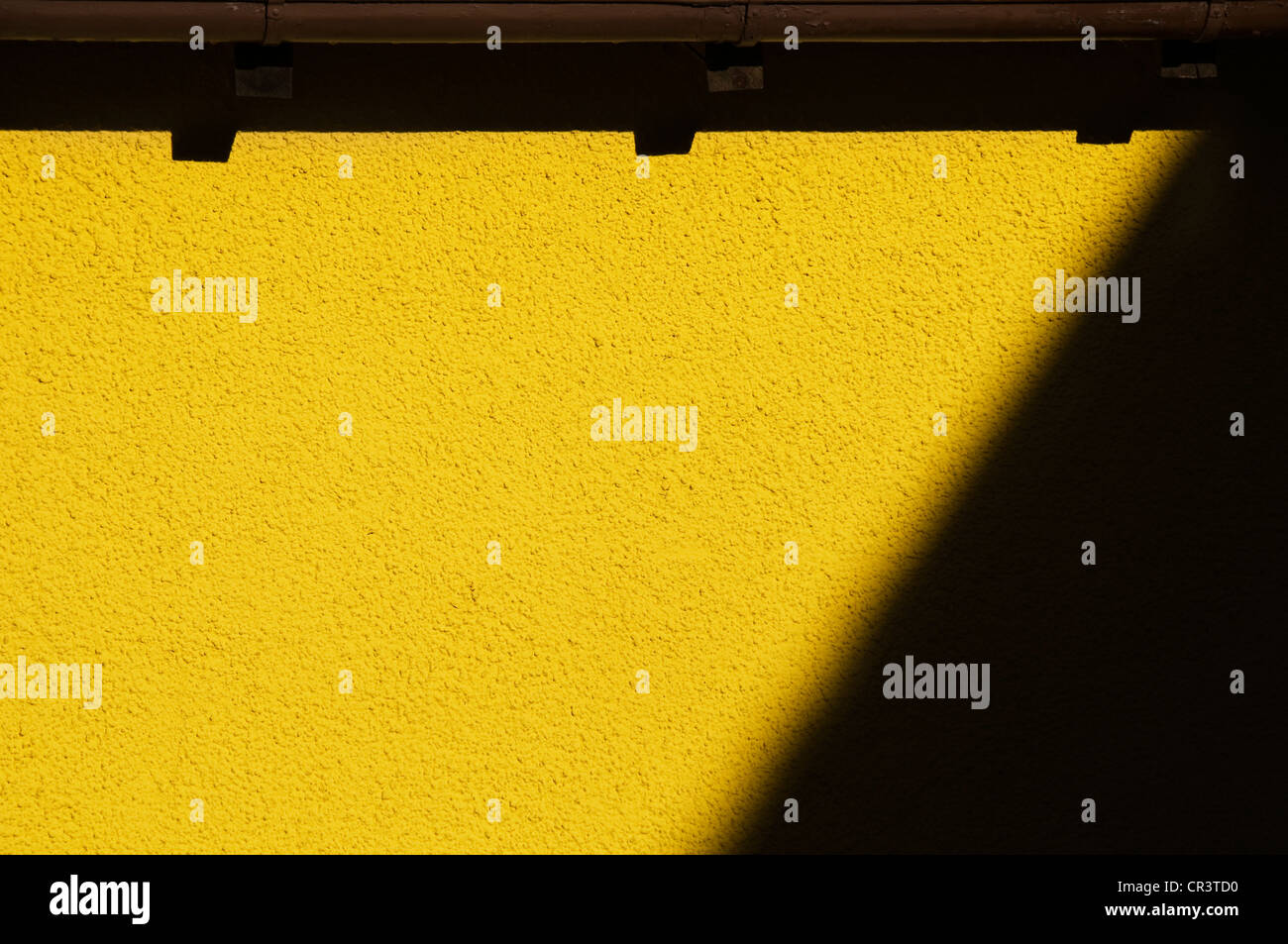 Light and shadow on a yellow wall Stock Photo - Alamy