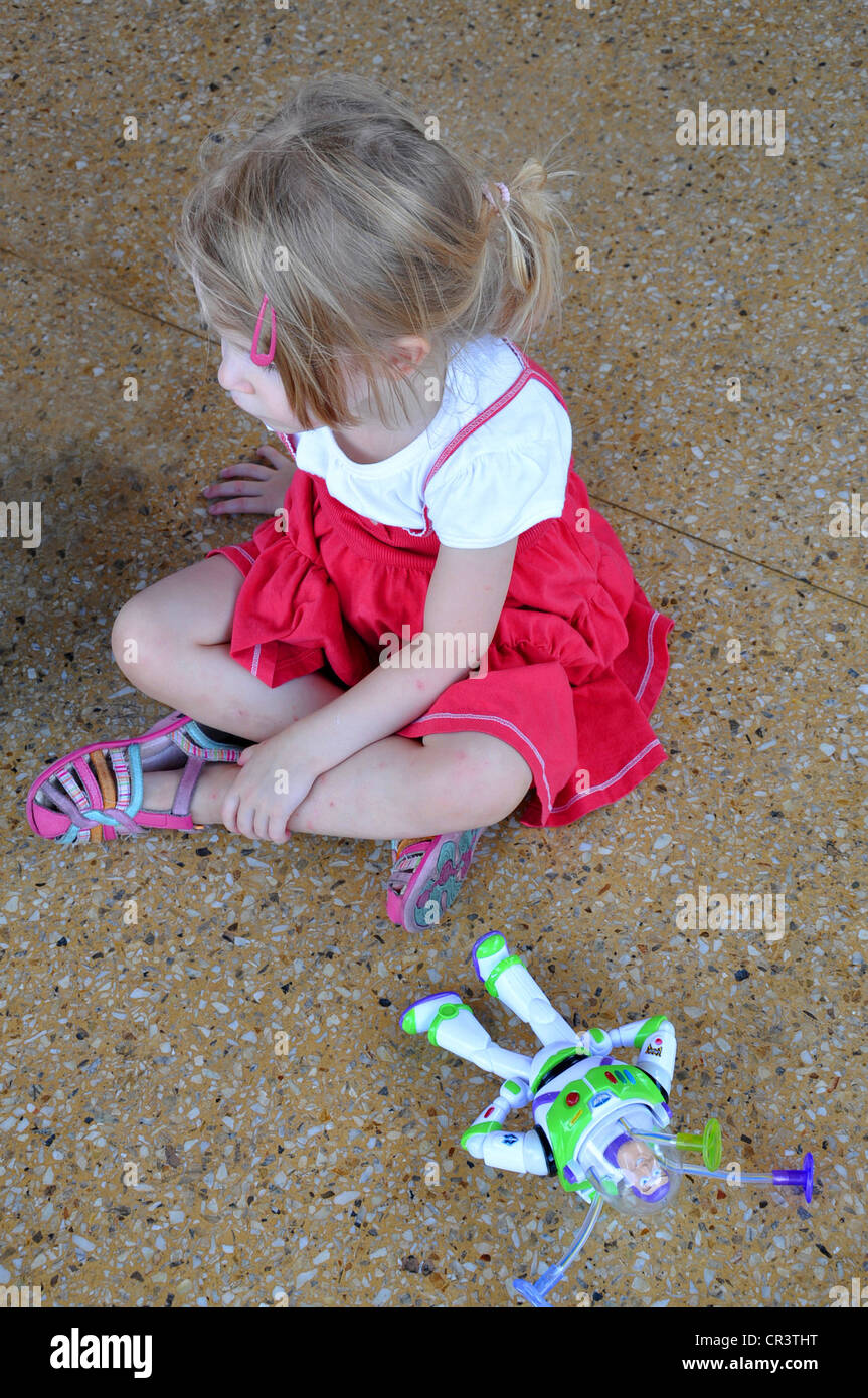 Little girl plays with Buzz Lightyear from the movie "Toy Story" at ...