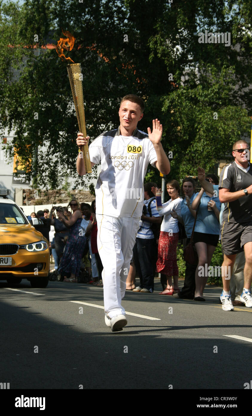 Olympic torch runner on Stow Hill in the city of Newport South Wales GB ...