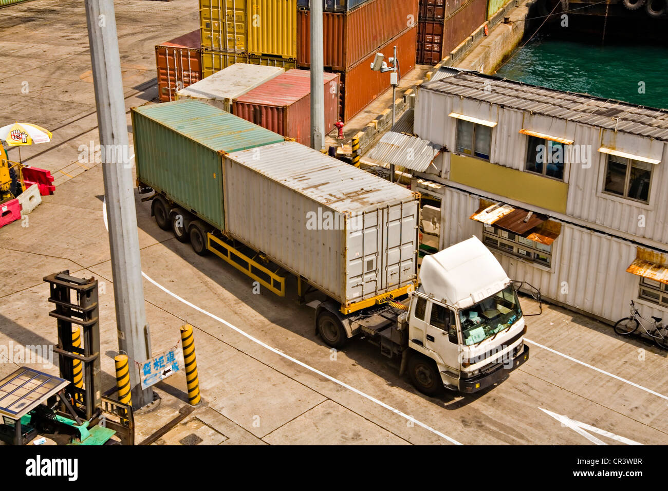 Shipping containers on semi-trailer leaving a container terminal on ...