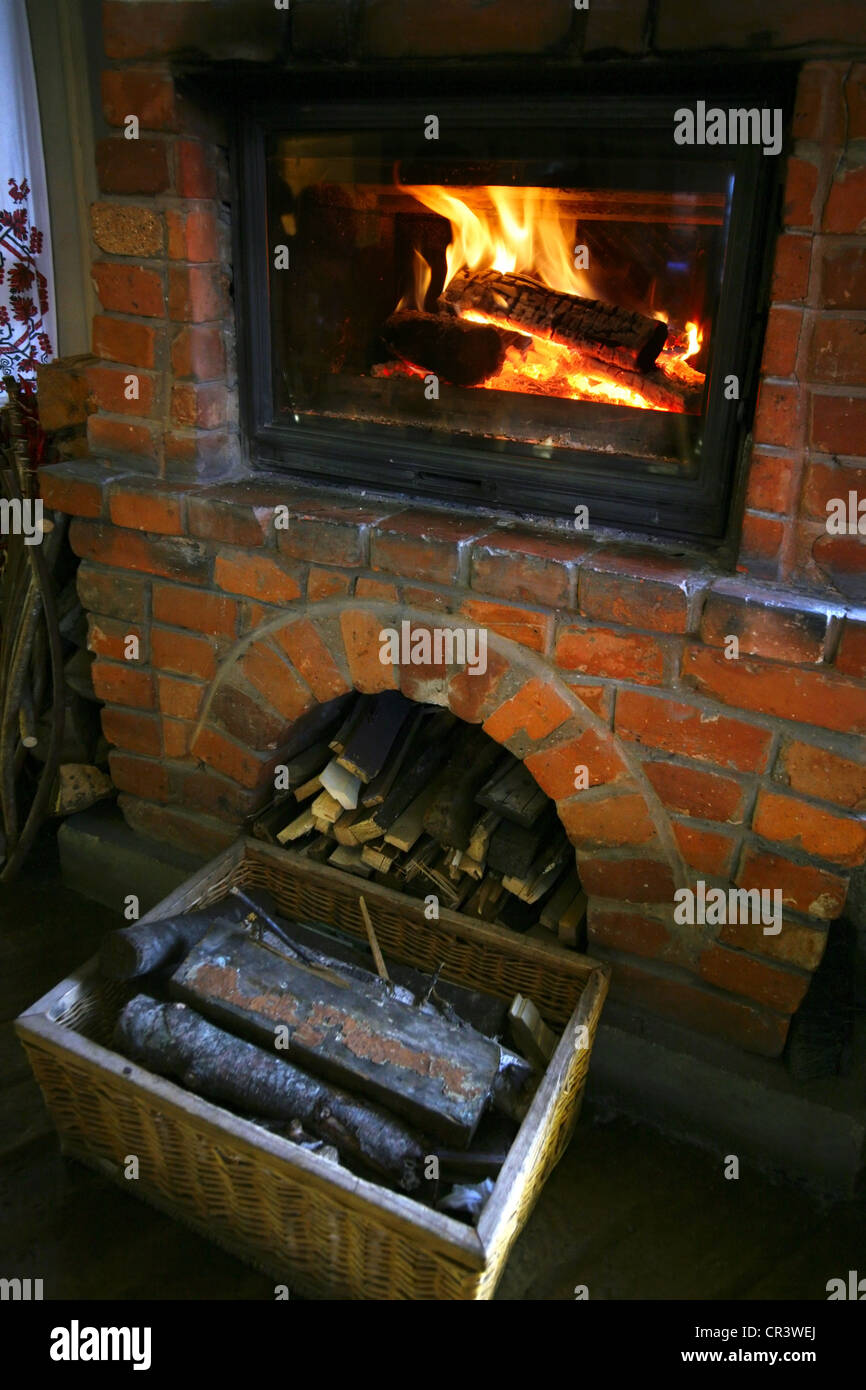 Interior with brick furnace and fire Stock Photo - Alamy