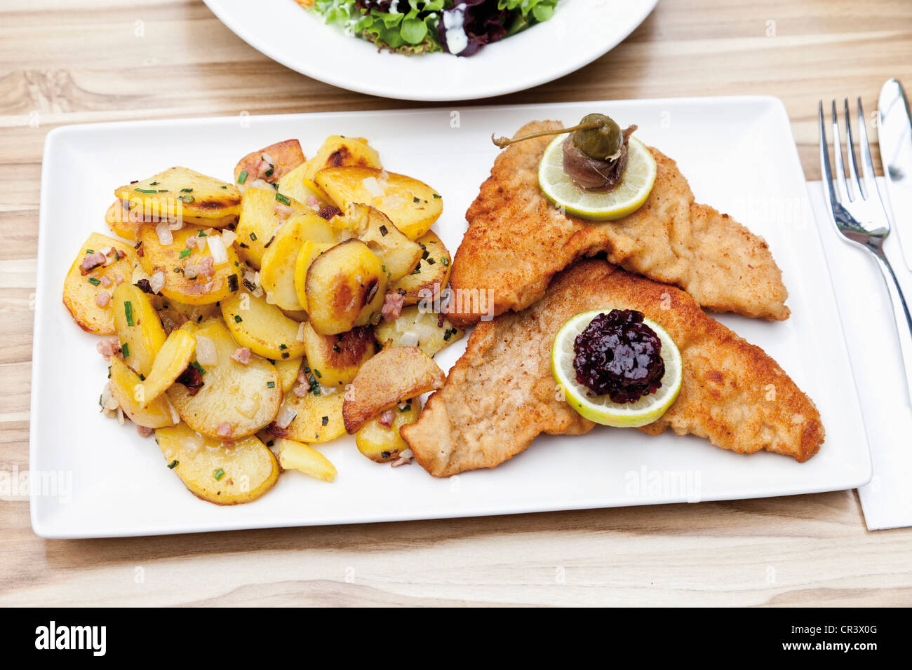 Wiener schnitzel with fried potatoes Stock Photo - Alamy