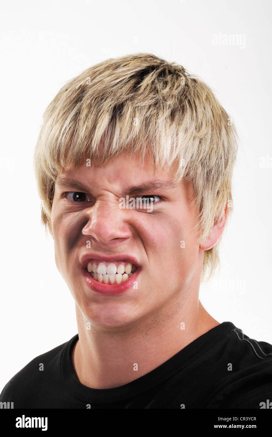 Young man with angry expression Stock Photo - Alamy