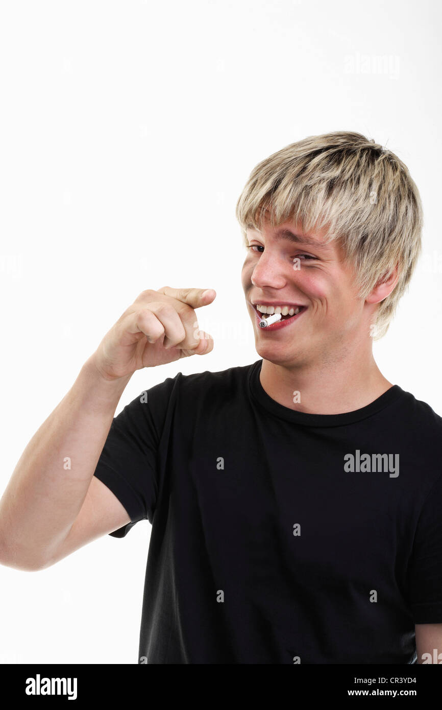 Young man with superior expressions and cigarette in his mouth gestures ...