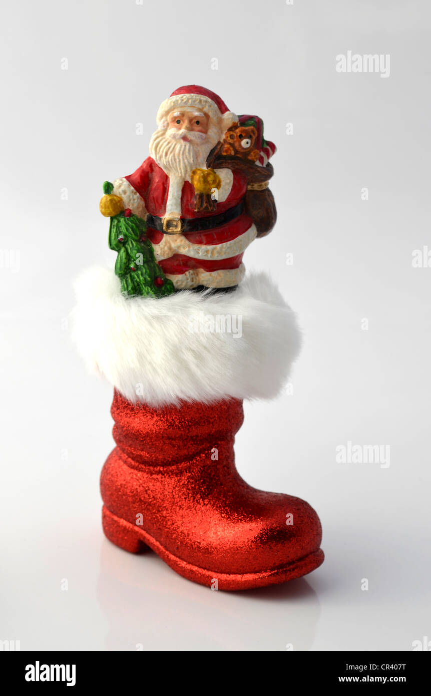 Santa Claus in a Christmas boot, with a bag with toys and gifts, wooden ...
