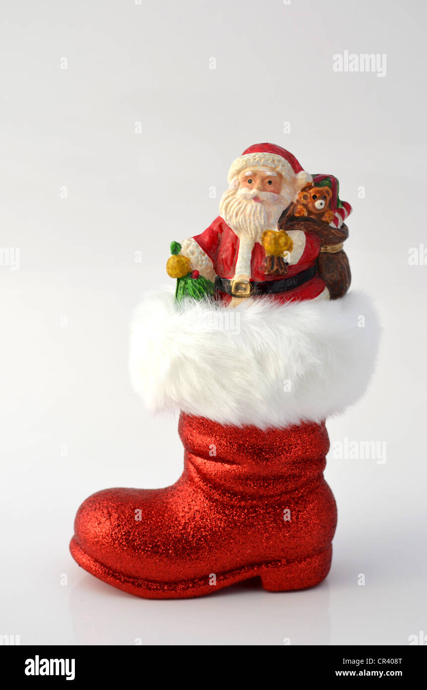 Santa Claus in a Christmas boot, with a bag with toys and gifts, wooden ...
