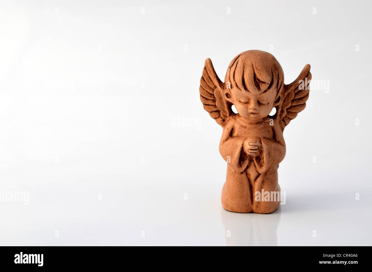 Little angel made of clay, praying Stock Photo - Alamy