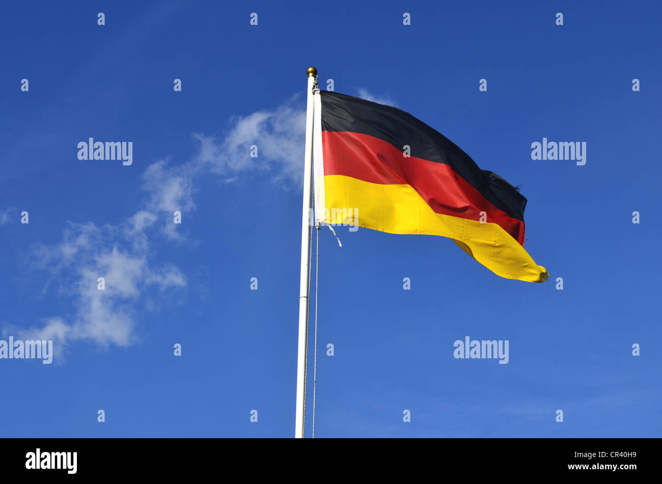German flag flying against a blue sky with clouds, Germany, Europe ...