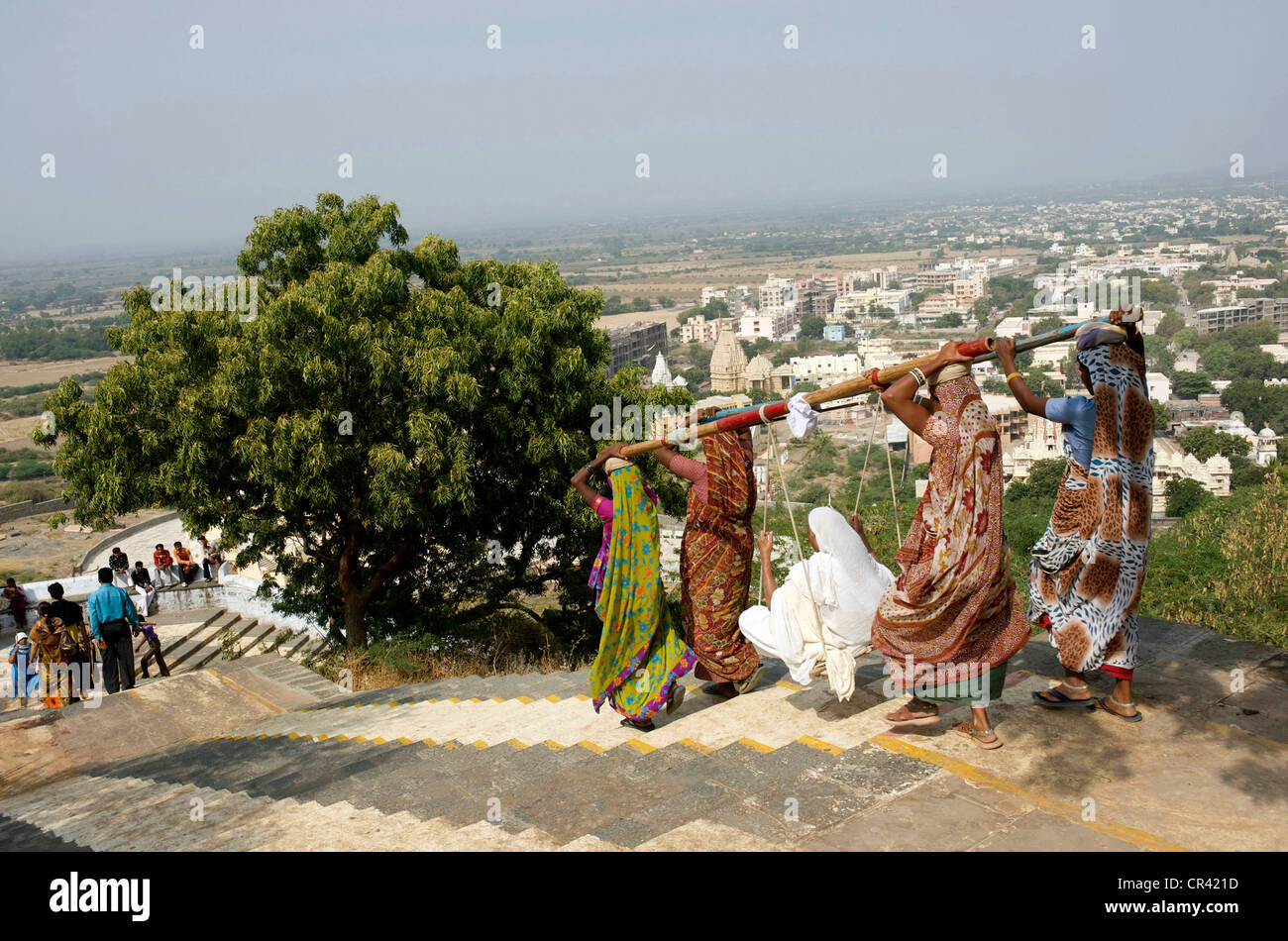 India, Gujarat State, Shatrunjaya Hill, pilgrims going down with doli ...