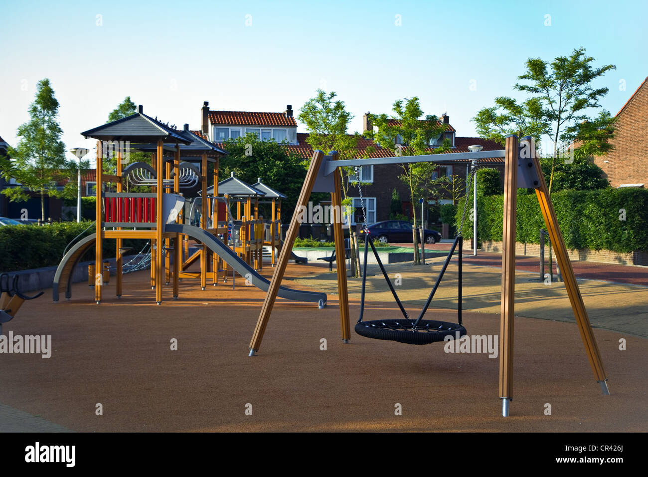 Public playground with colorful wooden climbing construction, swing ...