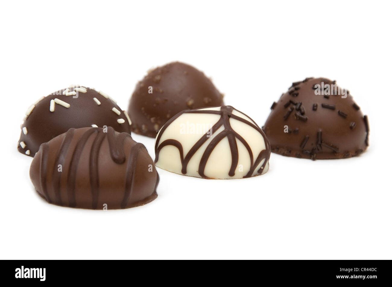 five chocolate candies with different flavors isolated on white ...