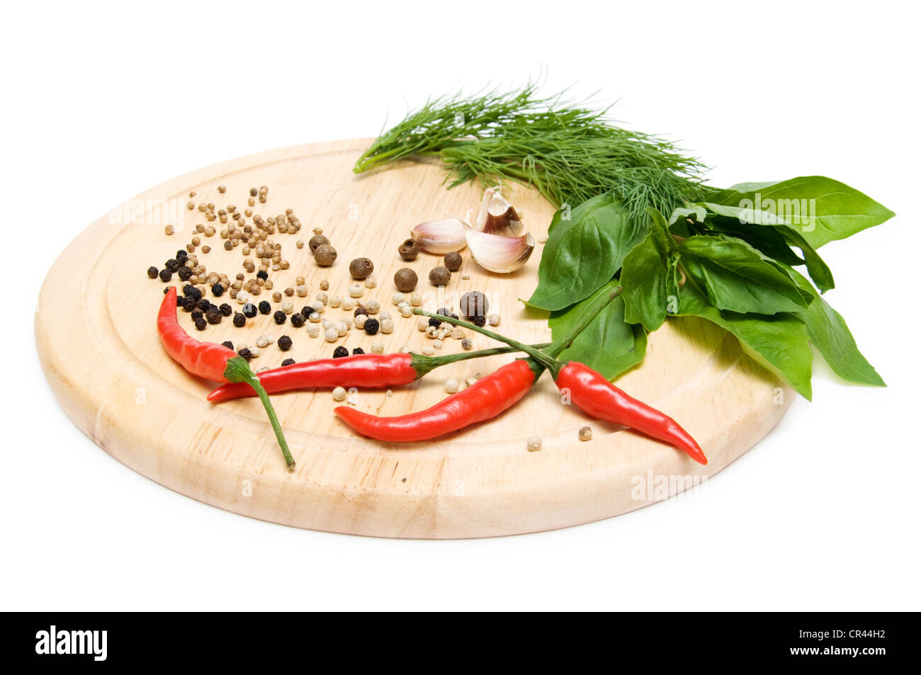 Spices and herbs on a cutting board isolated on white background Stock ...