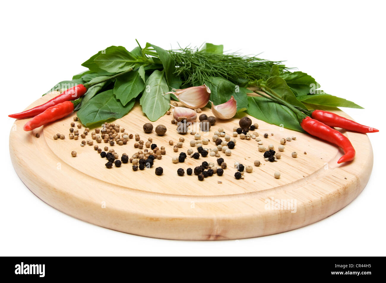 Spices and herbs on a cutting board isolated on white background Stock ...