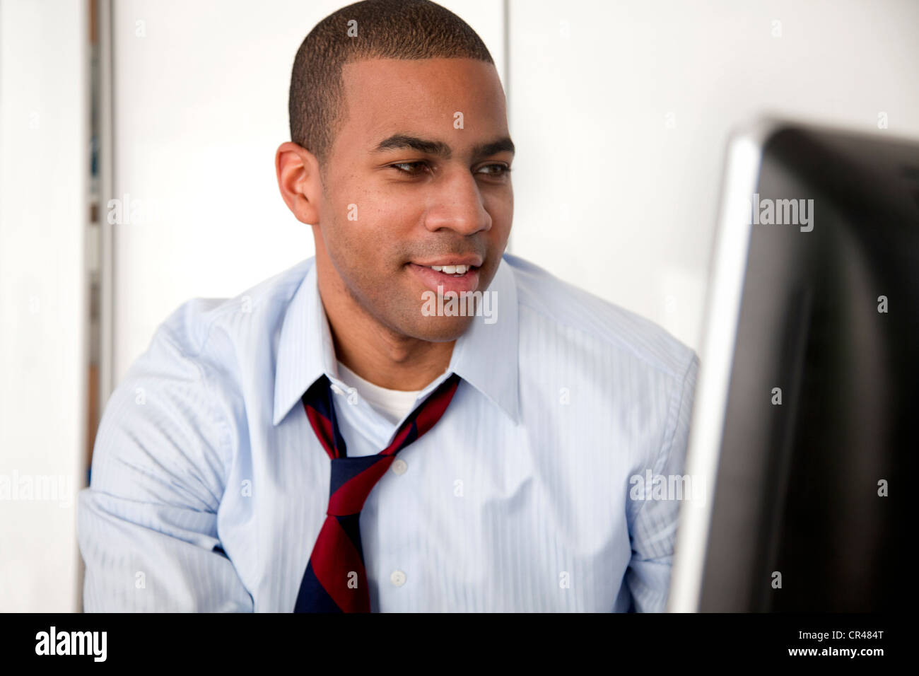 Black businessman working on computer Stock Photo - Alamy