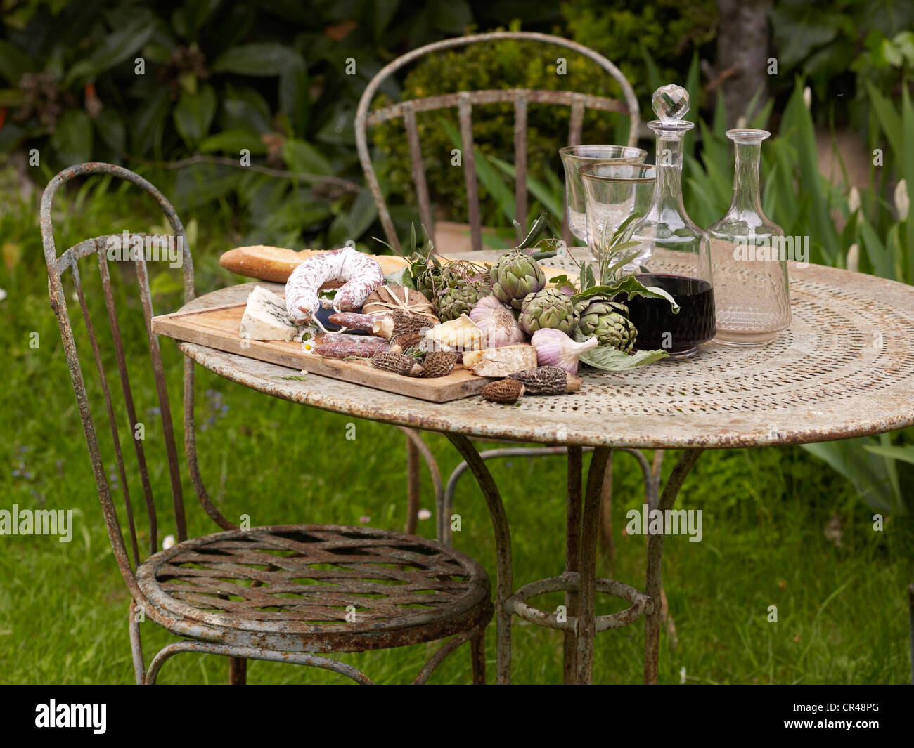 Mediterranean still life of a garden table covered with regional ...