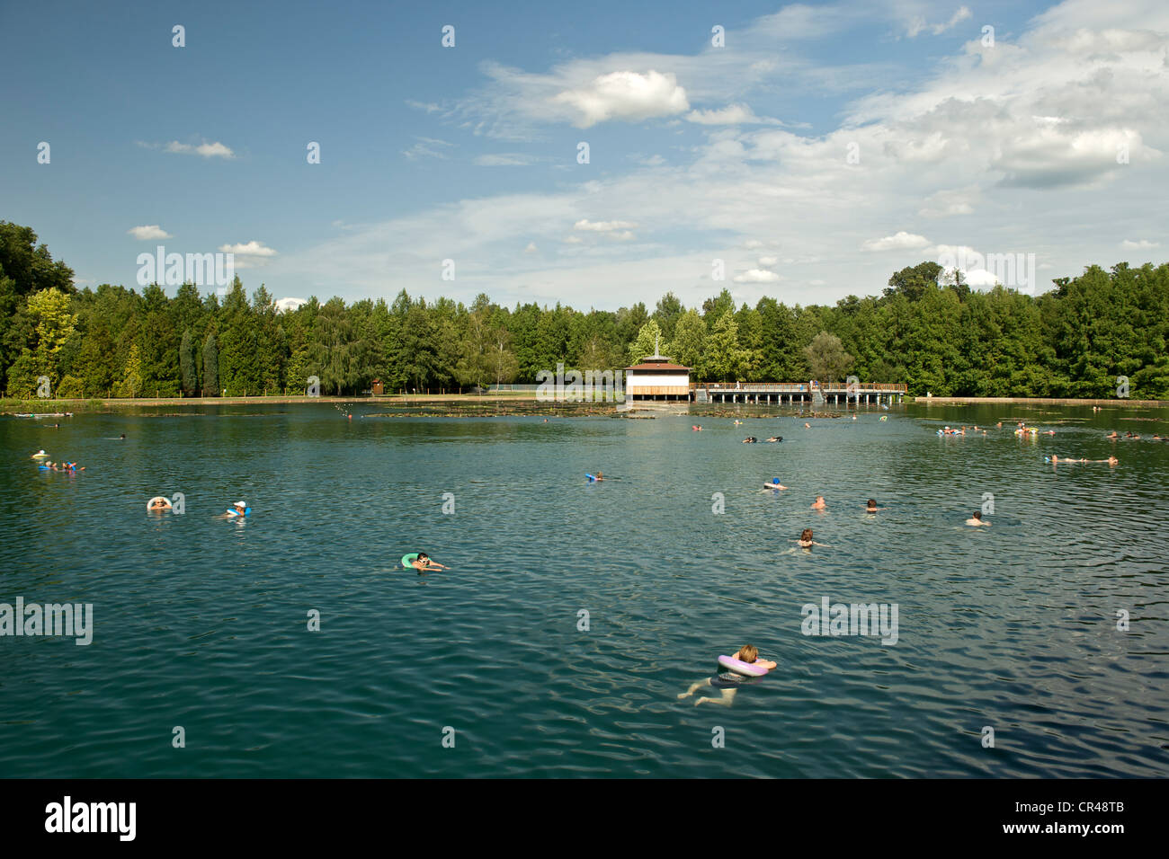 People swimming in the rejuvenating waters of Lake Heviz, a thermal ...