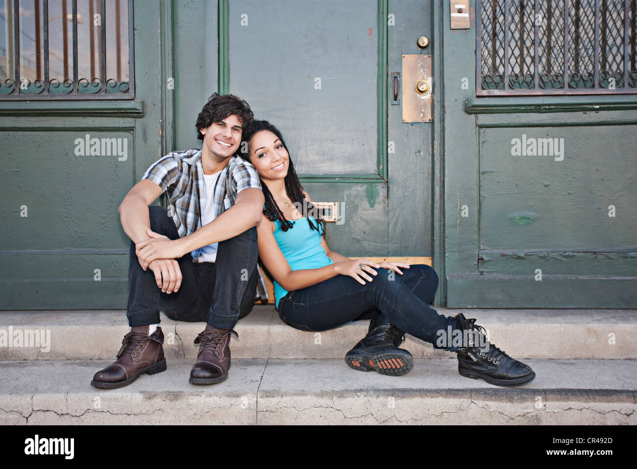 Couple leaning on each other on front stoop Stock Photo - Alamy