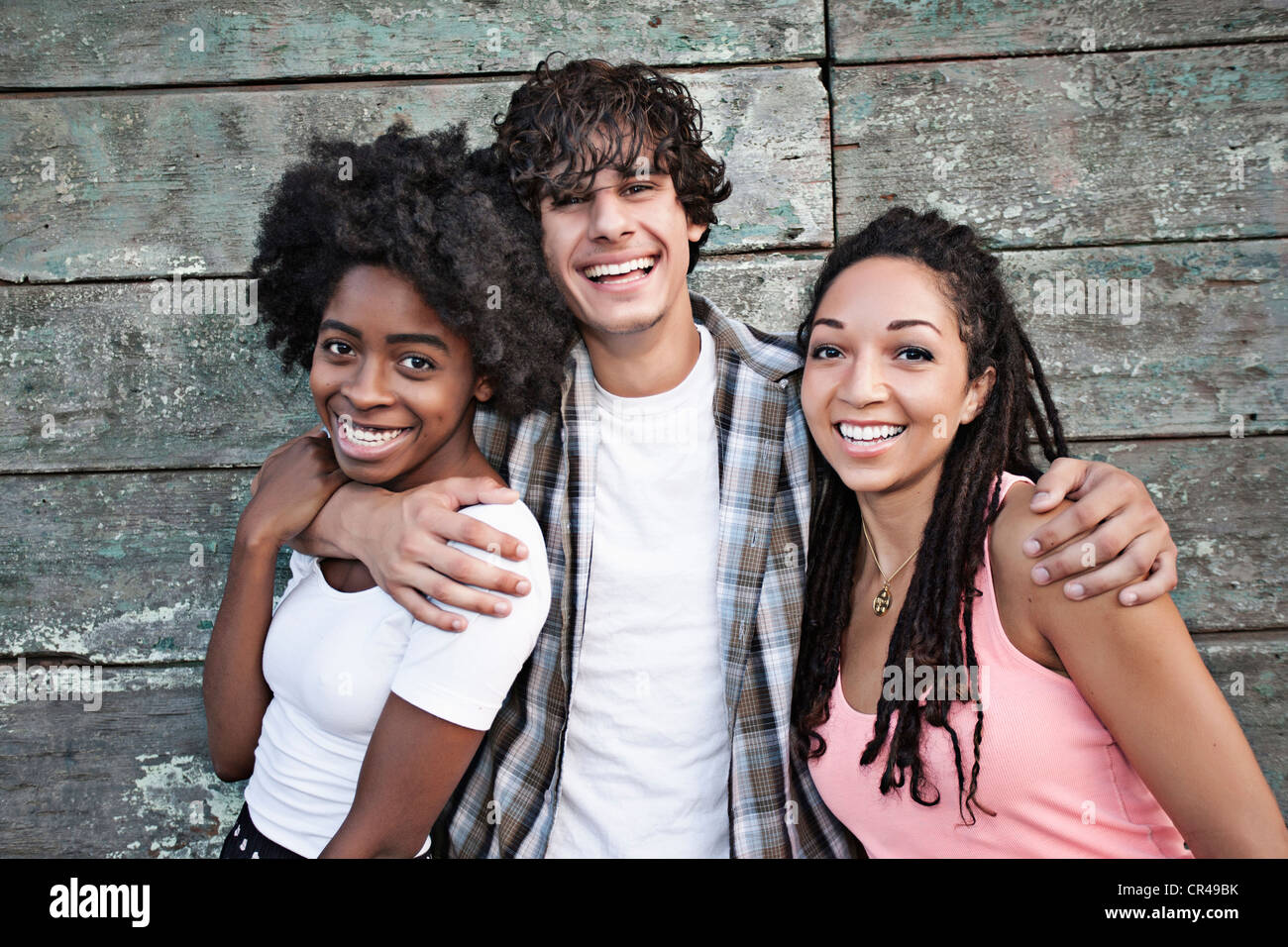 Smiling friends hugging Stock Photo - Alamy