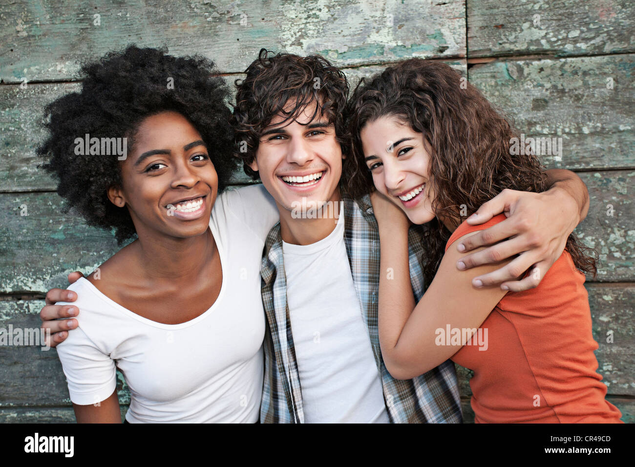 Smiling friends hugging Stock Photo - Alamy