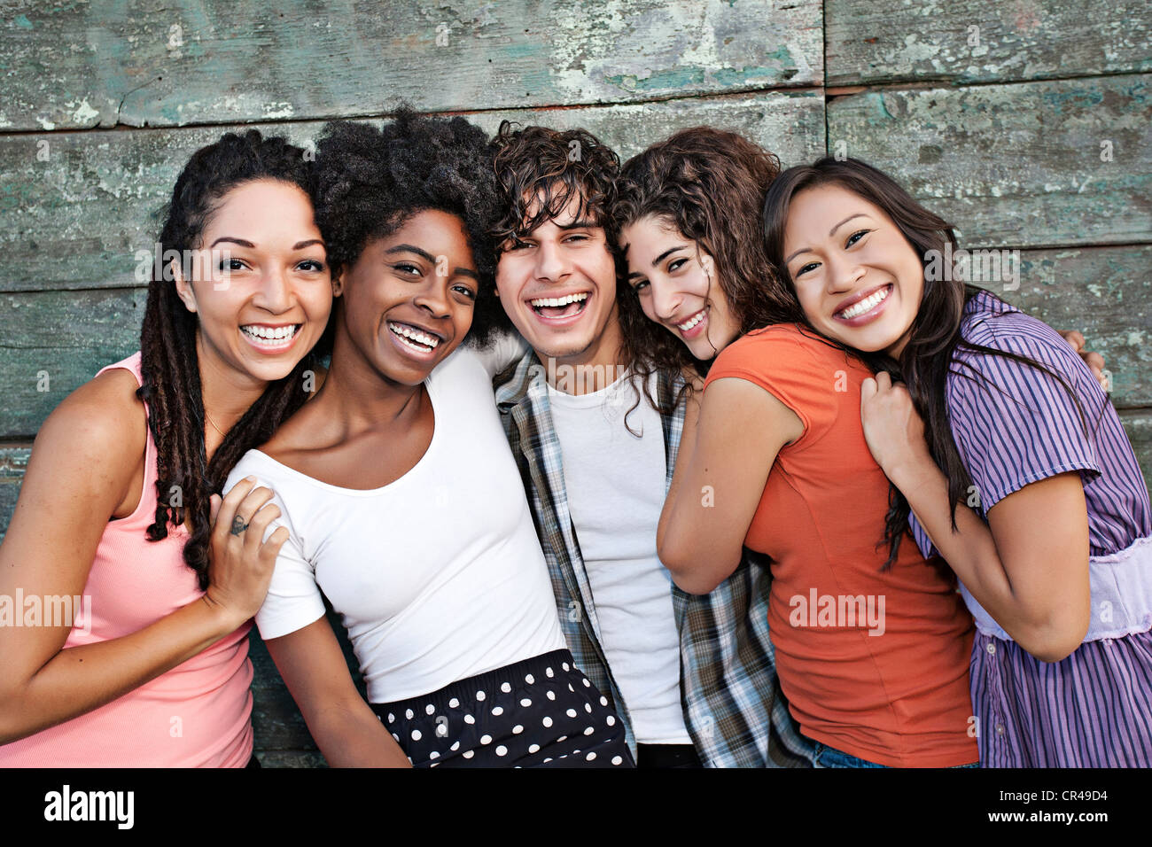 Smiling friends hugging Stock Photo - Alamy