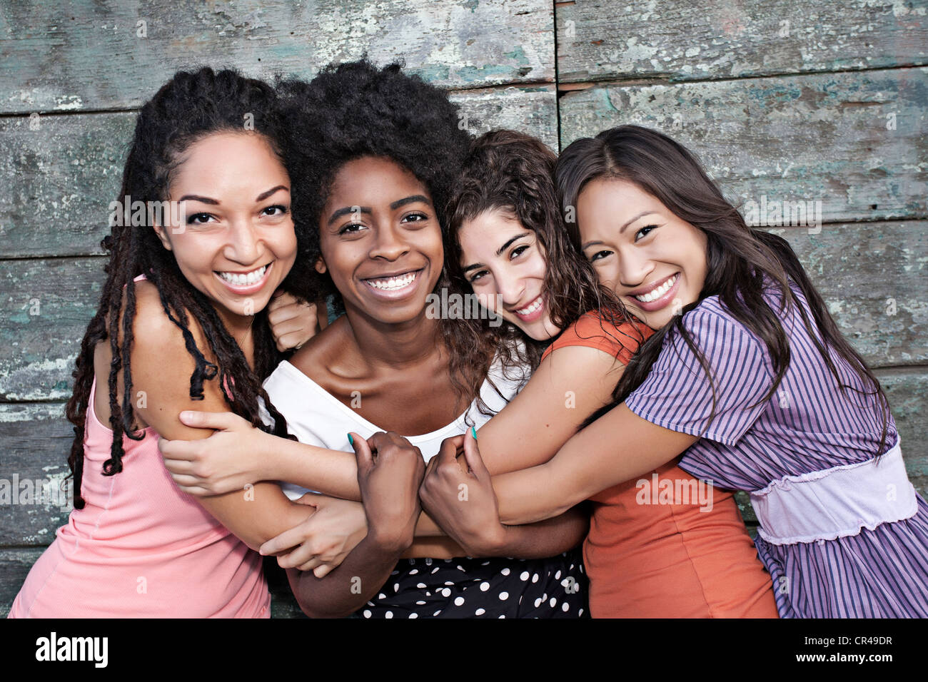 Smiling friends hugging Stock Photo - Alamy