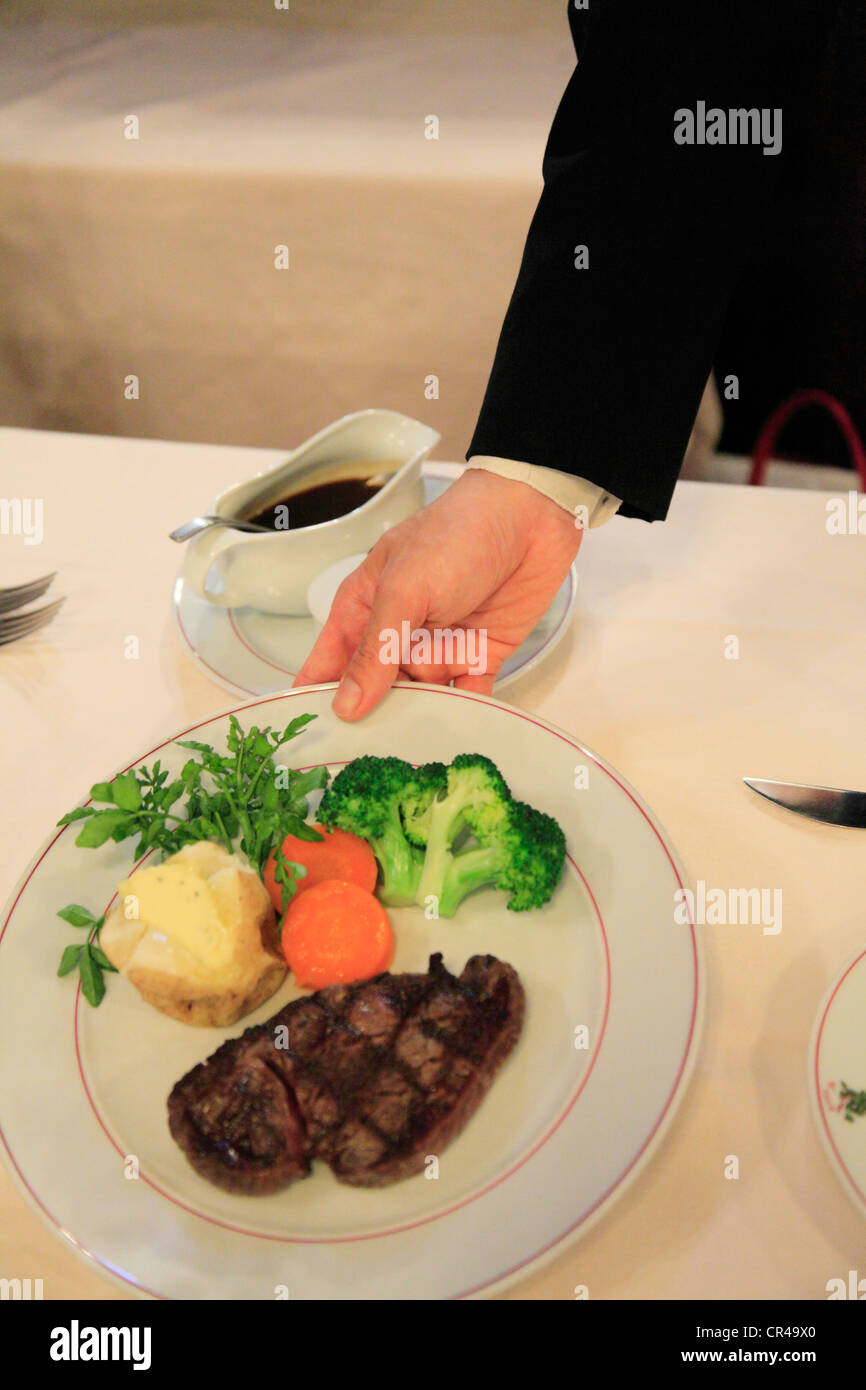 Waiter Serving Beef Steak Stock Photo - Alamy
