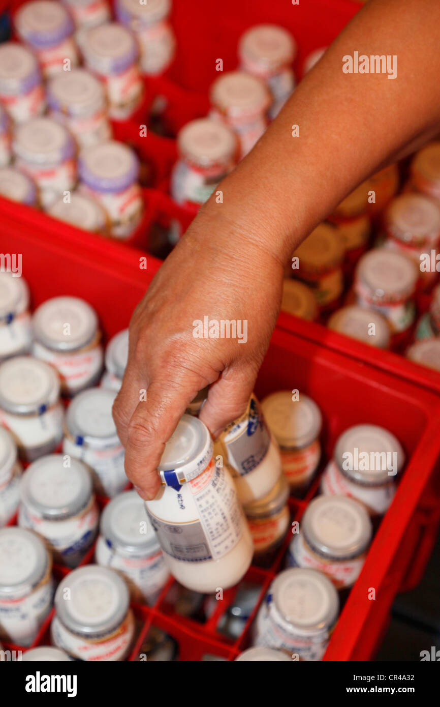Milkman Holding Two Bottles of Milk Stock Photo - Alamy