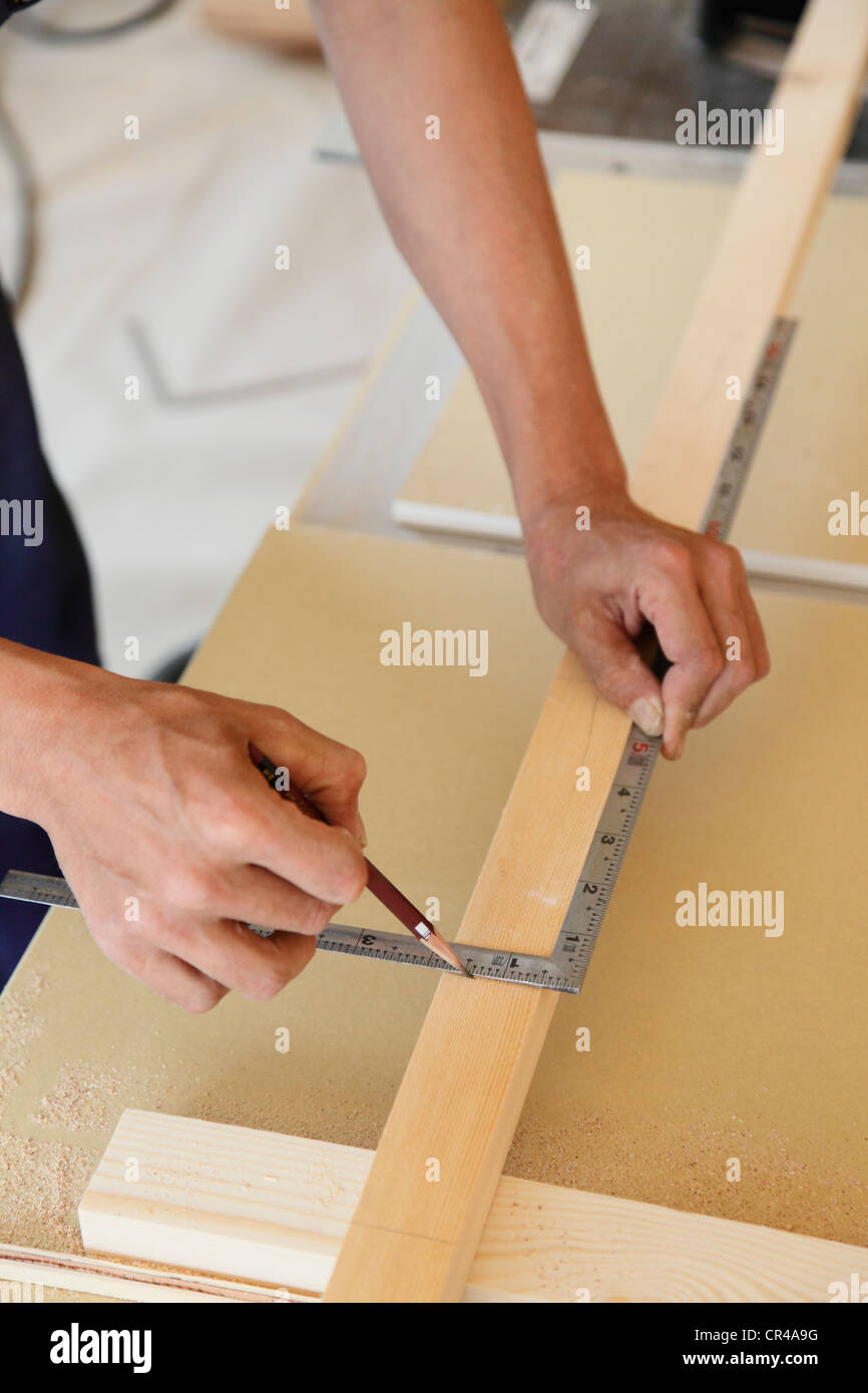 Carpenter Using Steel Square for Measuring Stock Photo - Alamy