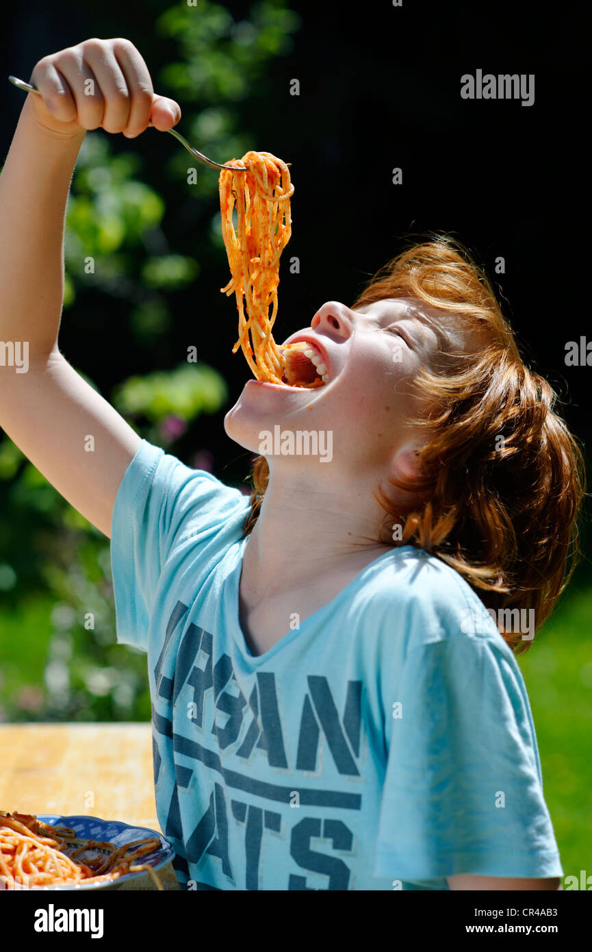 Red-haired boy, 10 years, eating spaghetti Stock Photo - Alamy