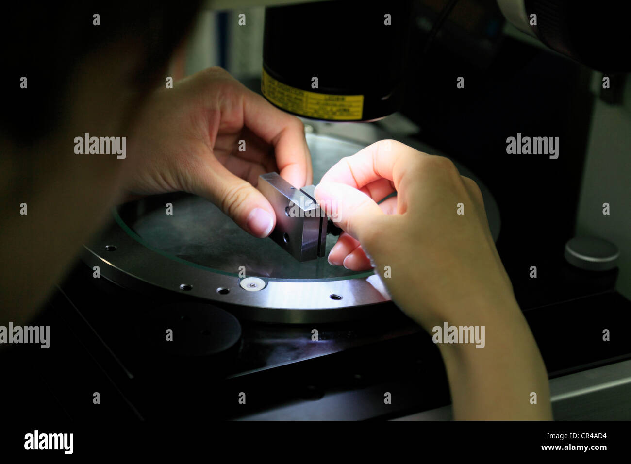 Machinery Operator Checking Part with Light Stock Photo - Alamy