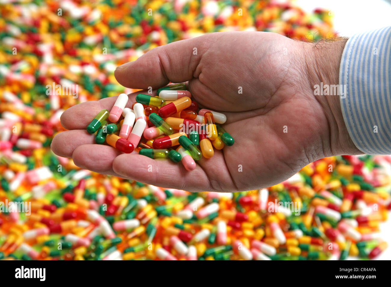 Hands full of medication pill capsules Stock Photo - Alamy