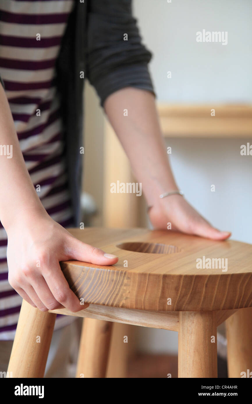 Young Woman Holding Stool Stock Photo - Alamy