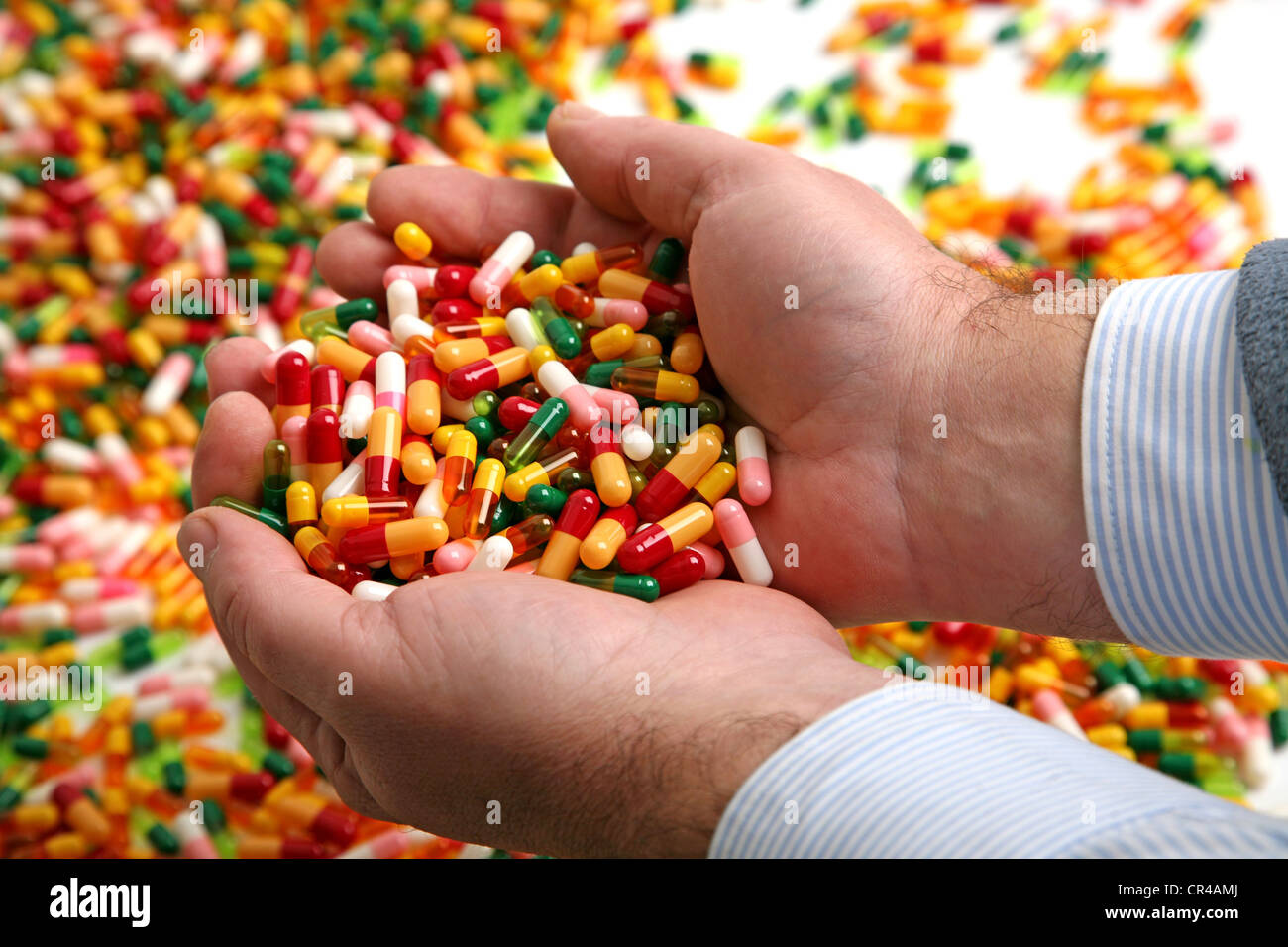 Hands full of medication pill capsules Stock Photo - Alamy