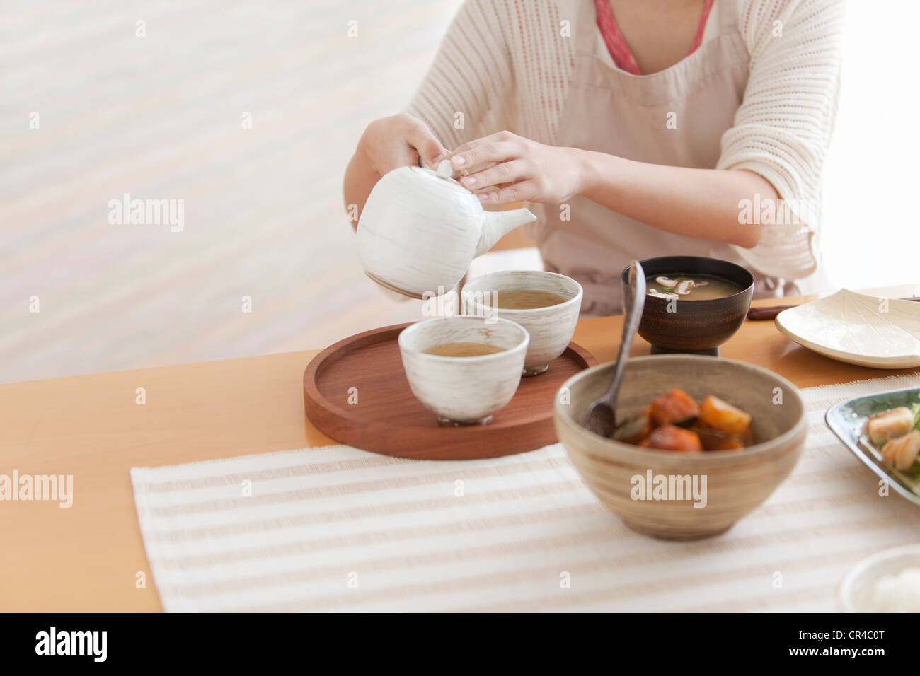 Young Woman Pouring Tea Stock Photo - Alamy