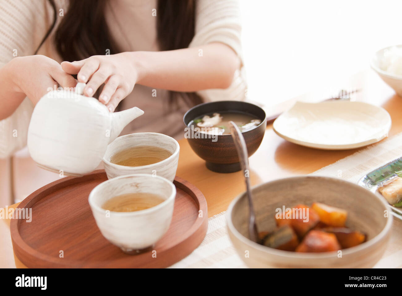 Young Woman Pouring Tea Stock Photo - Alamy