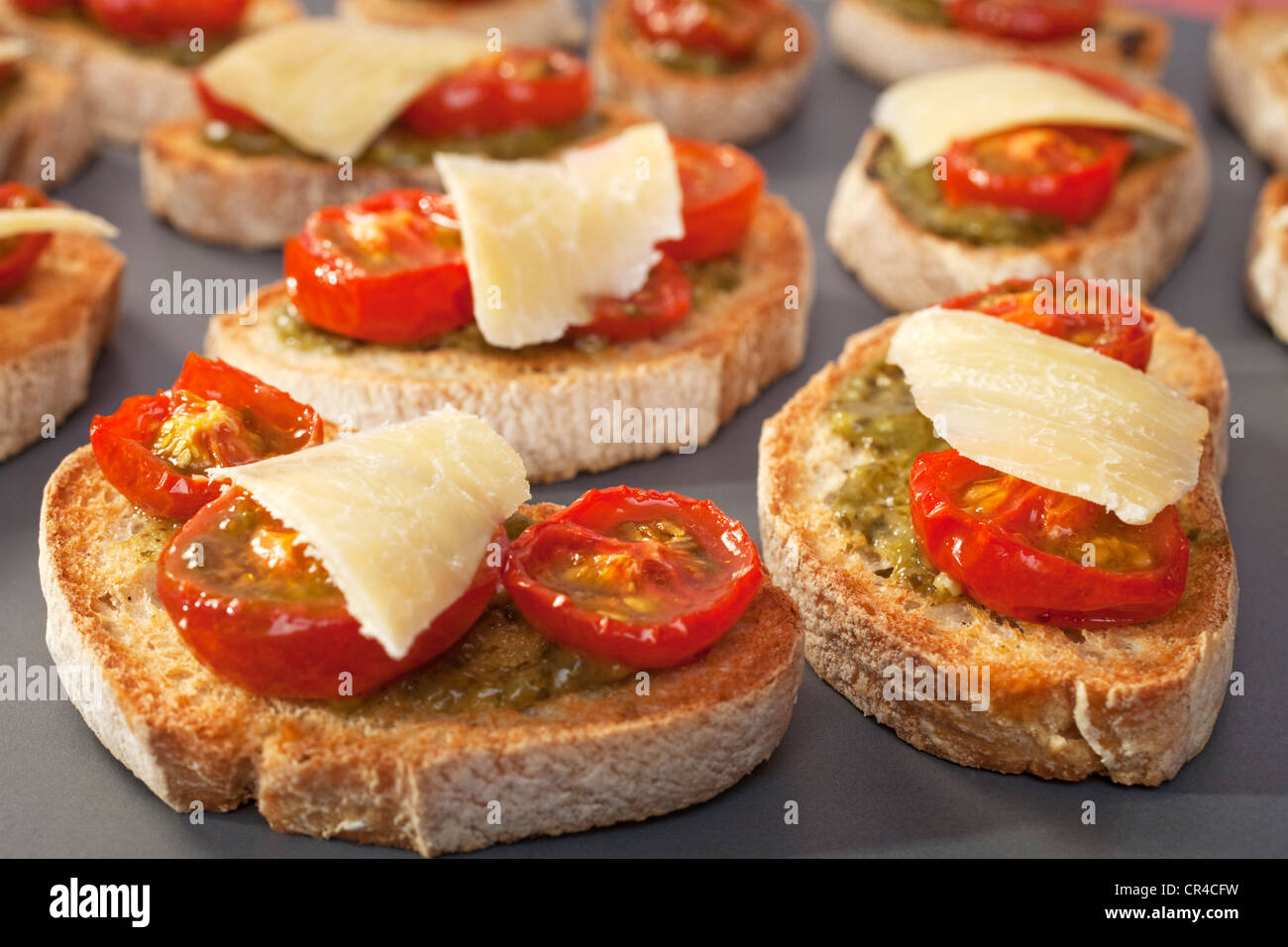 Italian focaccia bread is toasted and topped with basil pesto, roasted ...