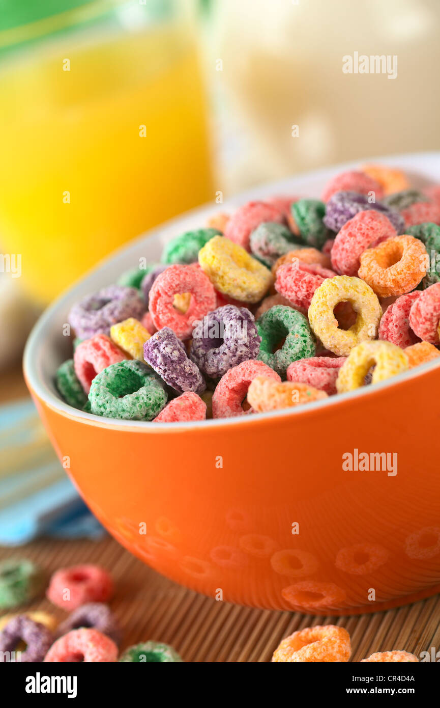 Colorful cereal loops with different fruit flavor in orange bowl with ...