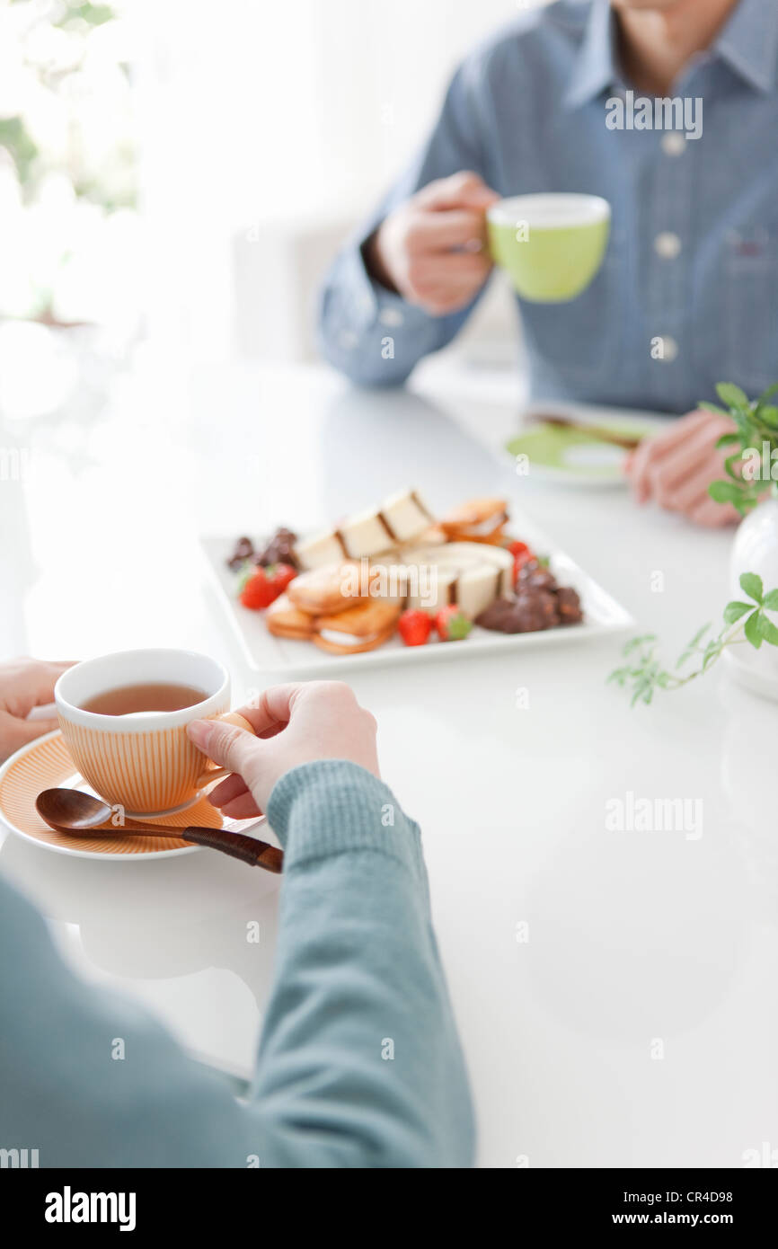 Smiling couple having teatime hi-res stock photography and images - Alamy