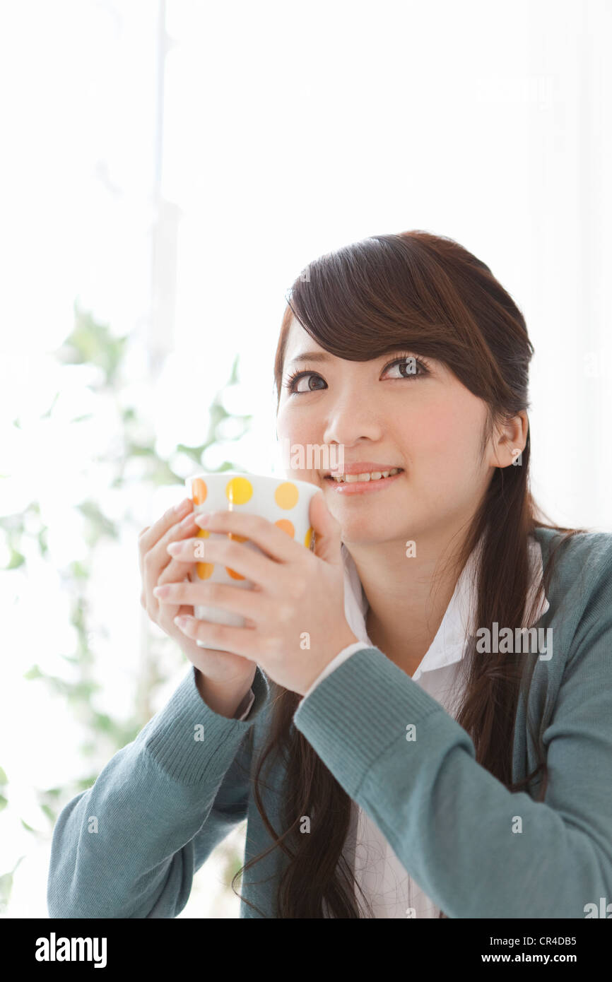 Young Woman Having Tea Stock Photo - Alamy