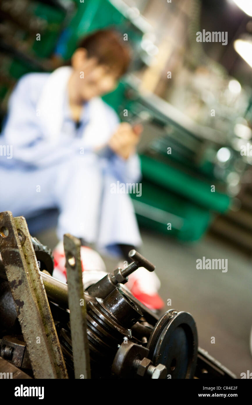 Tools In Foreground, Female Factory Worker In Background Stock Photo ...