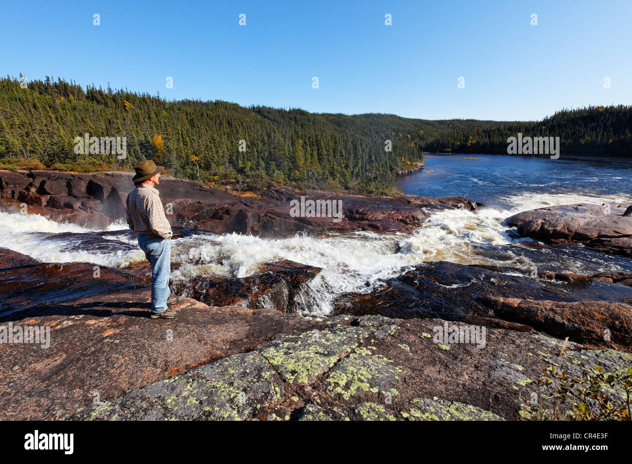 Tourist looking at Manitou river, Duplessis region, Quebec, Canada ...