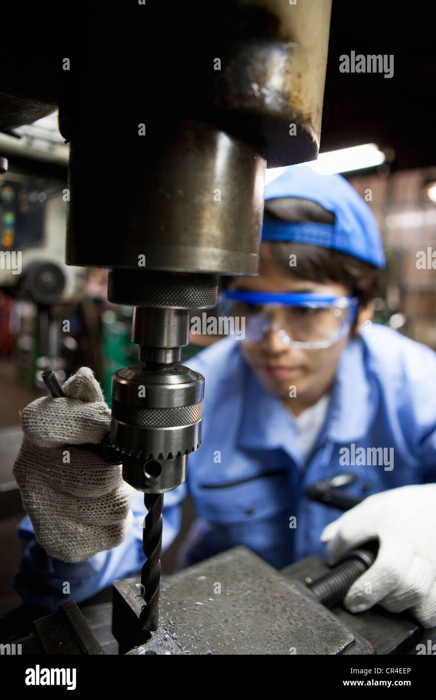 Young Man Using Industrial Drill Stock Photo - Alamy