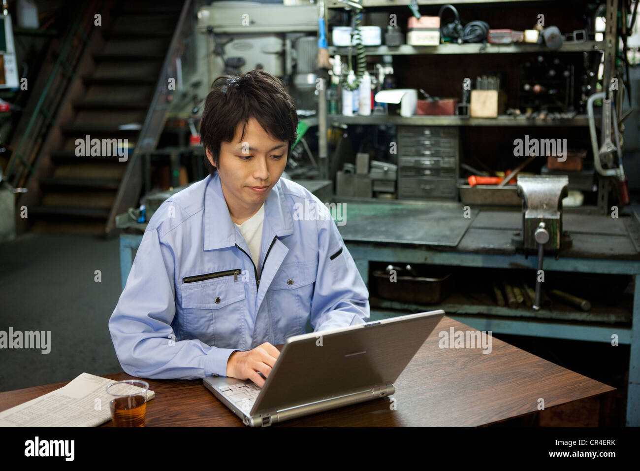 Male Factory Worker Using Laptop Stock Photo - Alamy