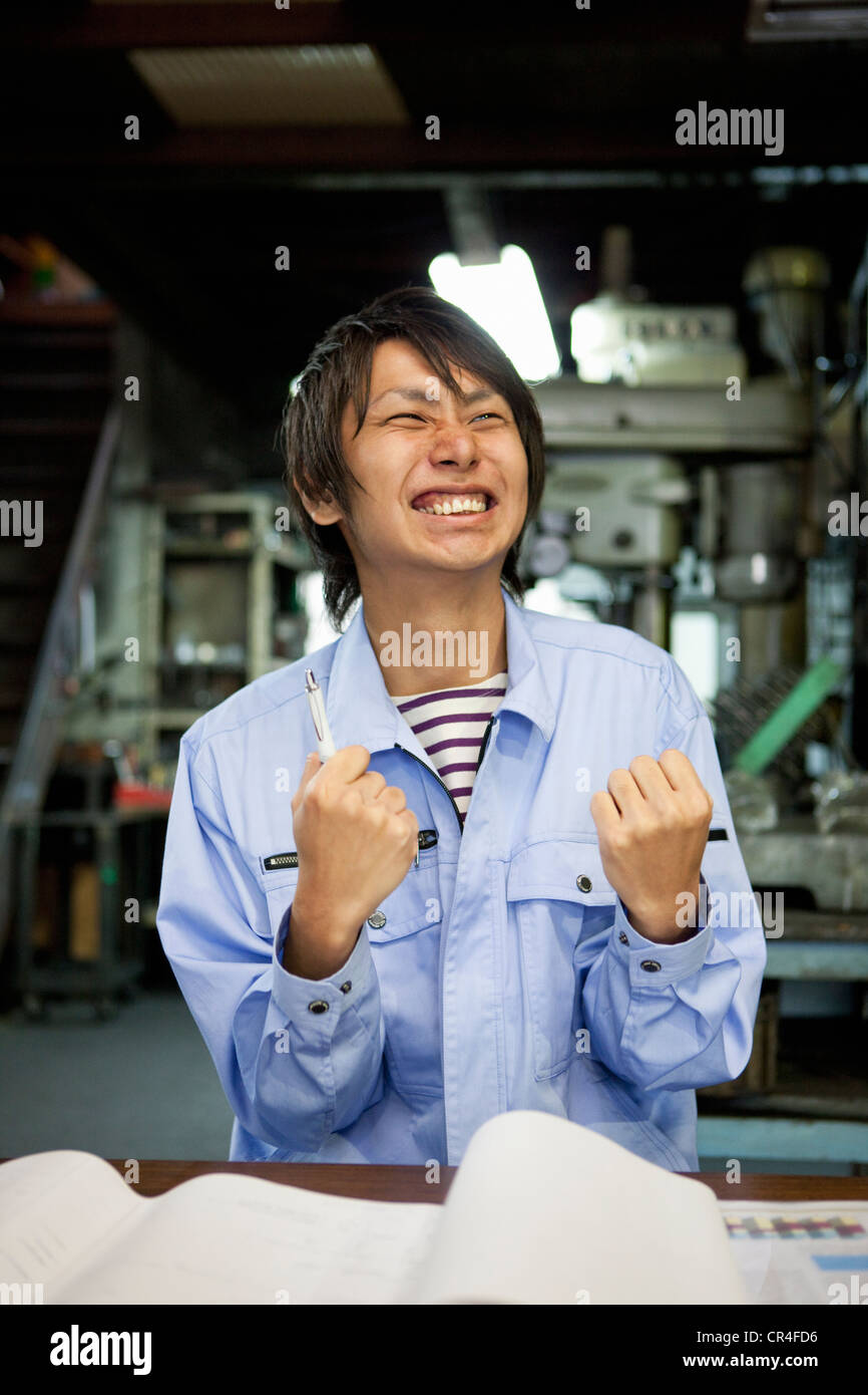 Male Factory Worker Cheering Stock Photo - Alamy