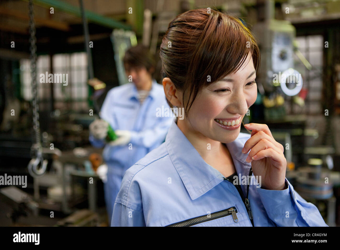 Happy Female Factory Worker Stock Photo - Alamy